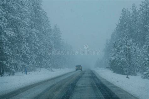 Big Pick Up Truck Drives Down A Dangerous Icy Road During A Severe