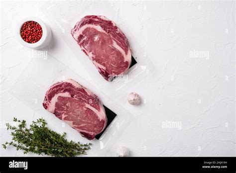 Premium Rib Eye Steak In A Vacuum Pack Set On White Stone Table