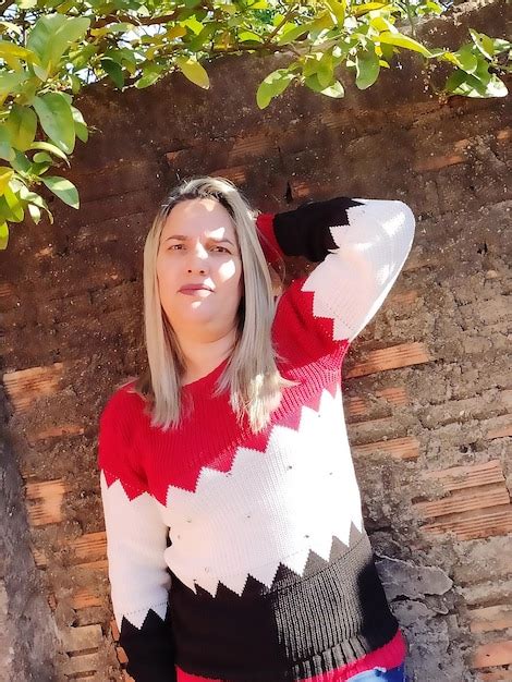 Premium Photo Portrait Of Woman Standing Against Brick Wall