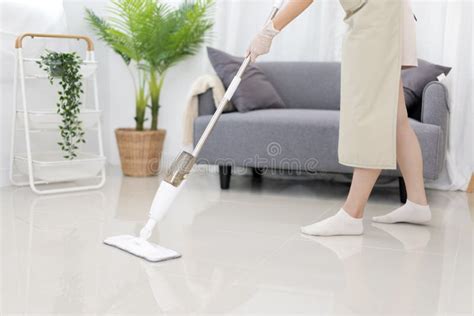 Beautiful Woman Mopping The Floor Of Her Living Room Stock Image