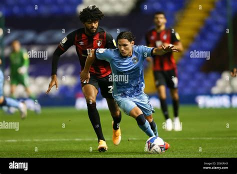 Callum Ohare Of Coventry City Runs Away From Philip Billing Of Afc