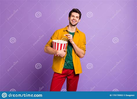 Portrait Of Positive Cheerful Guy Have Free Time Hold Big Pop Corn Box