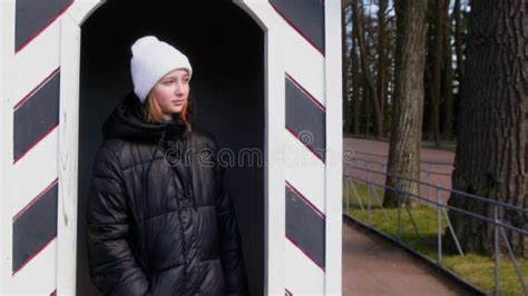 Thoughtful Teen Girl Walking Hiding From Wind In Summer House In Spring