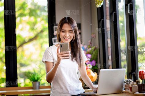 亚洲女性在咖啡馆工作笔记本电脑
