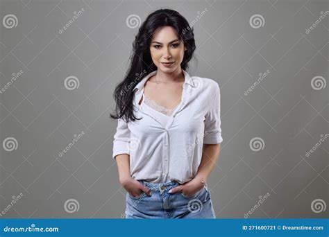 A Beautiful Brunette Woman In A Casual Outfit In The Studio Stock Image