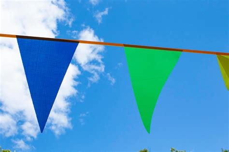 Premium Photo Bright Triangular Flags Against A Light Sky