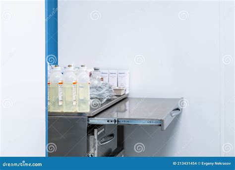 Saline Bottles For Intravenous Infusion In A Hospital On A Metal Table