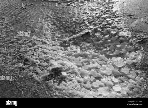 Detailed Close Up Of Icy Surface Displaying Varied Ice Patterns And Textures In Natural Light