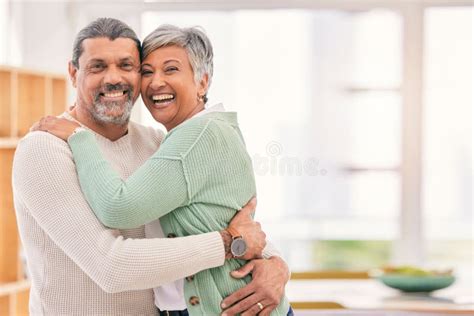 Happy Senior Couple Portrait And Hug With Love In Living Room Bonding
