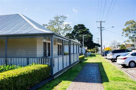 Image Of Weatherboard Home With Veranda Alongside Street In Country