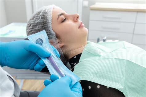 Dentist Preparing For Treatment In Dental Office Patient Laying In A