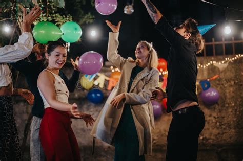 group of friends enjoying a vibrant birthday celebration outdoors at