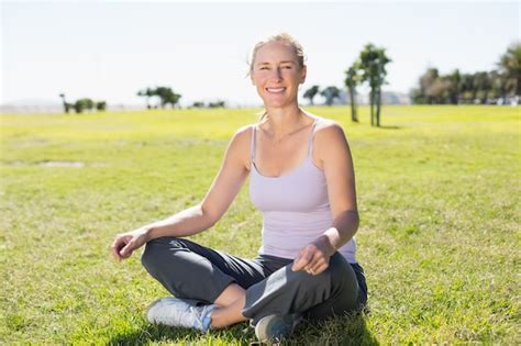 Premium Photo Fit Mature Woman Sitting In Lotus Pose On The Grass