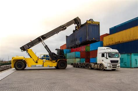 Truck While Loading In Logistic Shipping Yard With Cargo Container