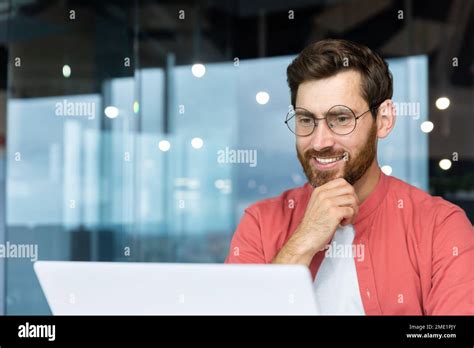 Successful smiling man working inside office with laptop, businessman ...