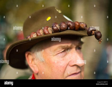 An Official Wears A Hat Decorated With Conkers At The 50th World Conker