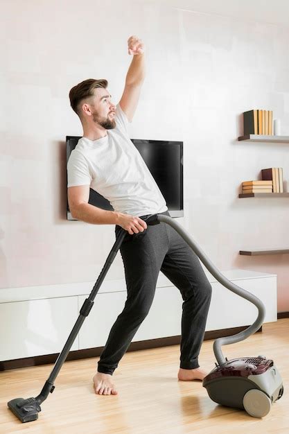 Free Photo Man Dancing With Vacuum Cleaner Long Shot