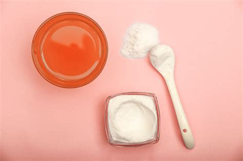 분홍색 배경에 콜라겐 파우더 추가 단백질 섭취 피부 뼈 관절 및 장건강을 위한 천연 미용 및 건강 보조 식품 식물 또는 생선 기반 플랫레이 상단 보기 텍스트의 공간을