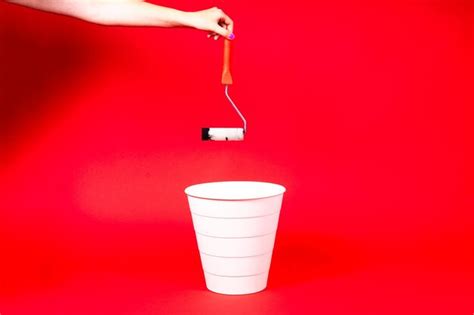 Premium Photo Construction Roller Is Thrown Into The Trash On A Red
