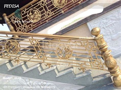 An Ornate Gold Railing On The Side Of A Building