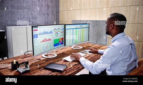 Computer Spreadsheet Data Analyst Man Using Multiple Screens Stock
