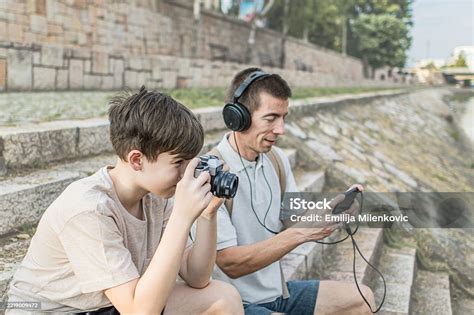 Old Skills Versus New Technology Father Teaching His Son How To Use Retro Photo Camera And How