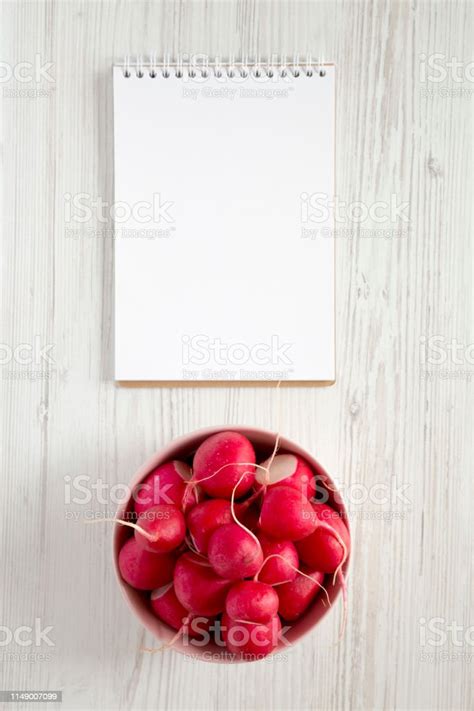 분홍색 그릇에 신선한 빨간색 라디안 흰색 나무 표면 위에 빈 메모장 평면도 평평한 평 신도 오버 헤드 위에서 복사 공간 농업에