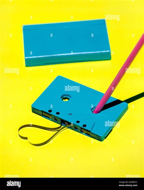High Angle Of Blue Retro Cassette With Messy Magnetic Tape And Pencil