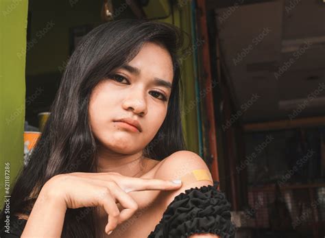 A Pretty Asian Girl Gives A Flirty Pout Over A Small Cut Or Wound