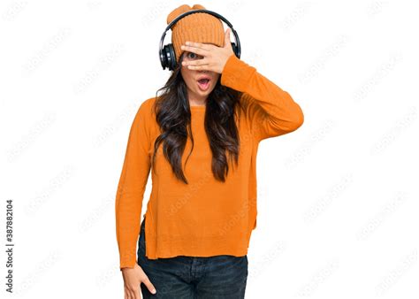 Beautiful Brunette Young Woman Listening To Music Using Headphones