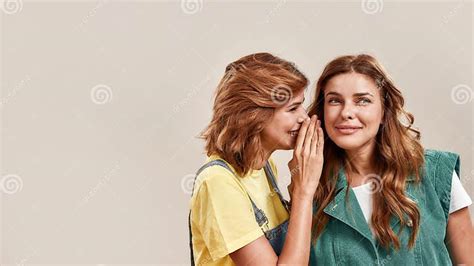 Close Up Portrait Of Two Attractive Young Girls Twin Sisters In Casual