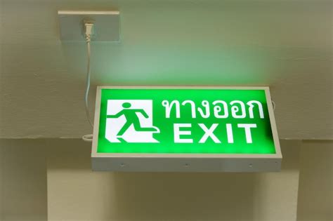 Premium Photo Low Angle View Of Illuminated Exit Sign With Text On Wall