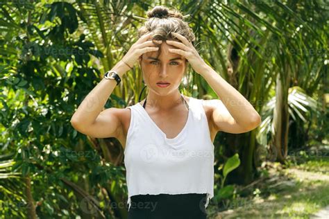 Stunning Woman With Beautiful Tanned Skin In The Tropical Garden