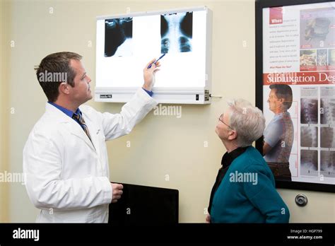Chiropractor Shows Patient Neck X Ray Stock Photo Alamy