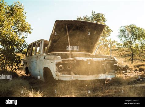 Old Damaged Broken Crashed White Car With An Open Hood In Nature On A Sunny Day Stock Photo Alamy