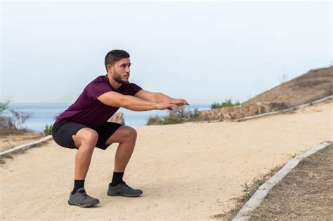Premium Photo Young Athlete Man Doing Squats Outdoor