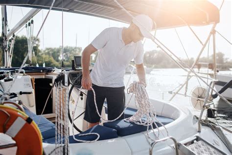Serious And Concentrated Sailor Stand On Yacht He Looks Down Guy