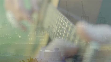 Man Playing Acoustic Guitar On Rooftop Overlaying Animated Technology