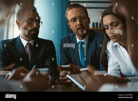 Young Team Of Colleagues App Developers Testing The Bugs Of The New App While Testing Usability