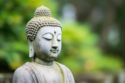 Premium AI Image A Stone Statue Of Buddha In Serene Meditation