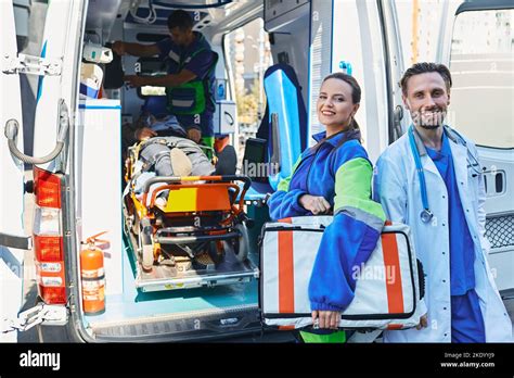 Portrait Of Beautiful Paramedic Woman And Hospital Doctor Standing