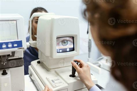 Doctor Testing For Eyes With Special Optical Apparatus In Modern Clinic