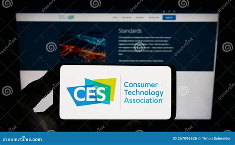 Person Holding Smartphone With Logo Of Us Consumer Technology