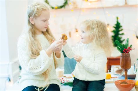 Two Cute Little Sisters Girls With Blond Curly Hair At The Christmas