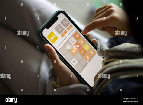 A Girl Plays The Game On An Iphone On February The Math
