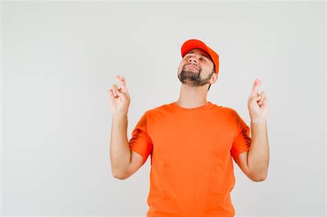 Free Photo Delivery Man Holding Cardboard Box With Thumb Up In Orange