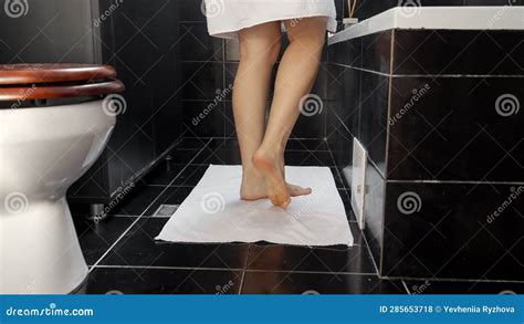 Closeup Of Woman Throwing Towel On Floor And Walking In Bath Female