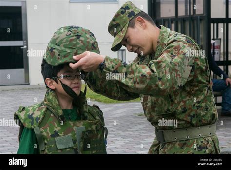 A Japanese Ground Self Defense Force Jgsdf Member Places A Kevlar