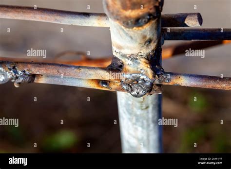 Welded Together Metal Fastening Parts Part Of A Rustic Fence Made Of