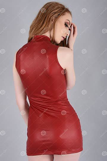Beautiful Tall Slim Busty Redhead Model In A Short Tight Red Pvc